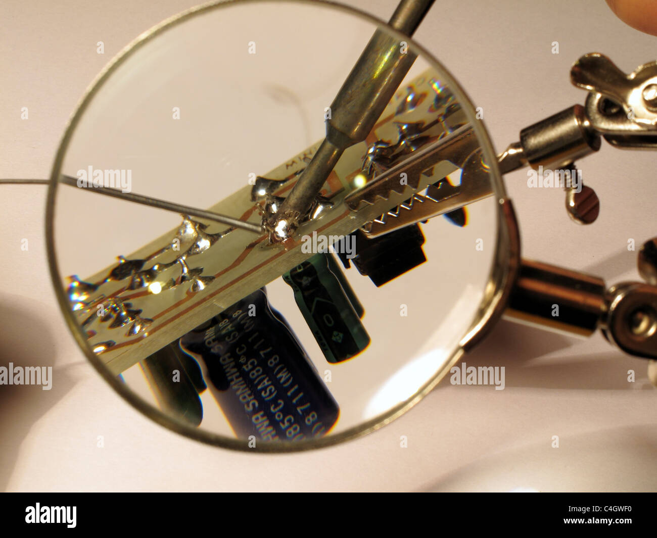 Solder the circuit board with a soldering iron hi-res stock photography ...