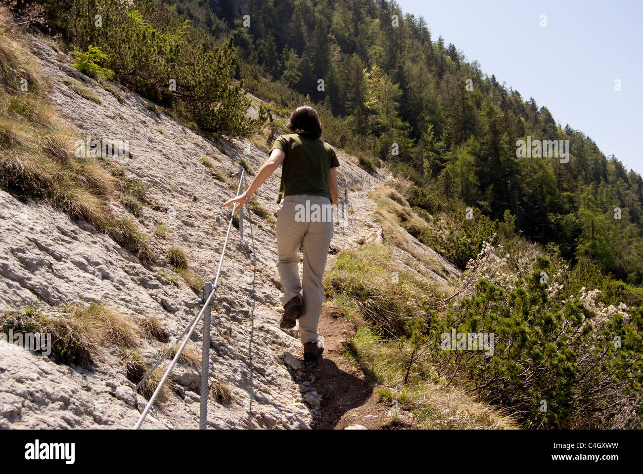 Girl walking along path on open grassy hillside Stock Photo - Alamy