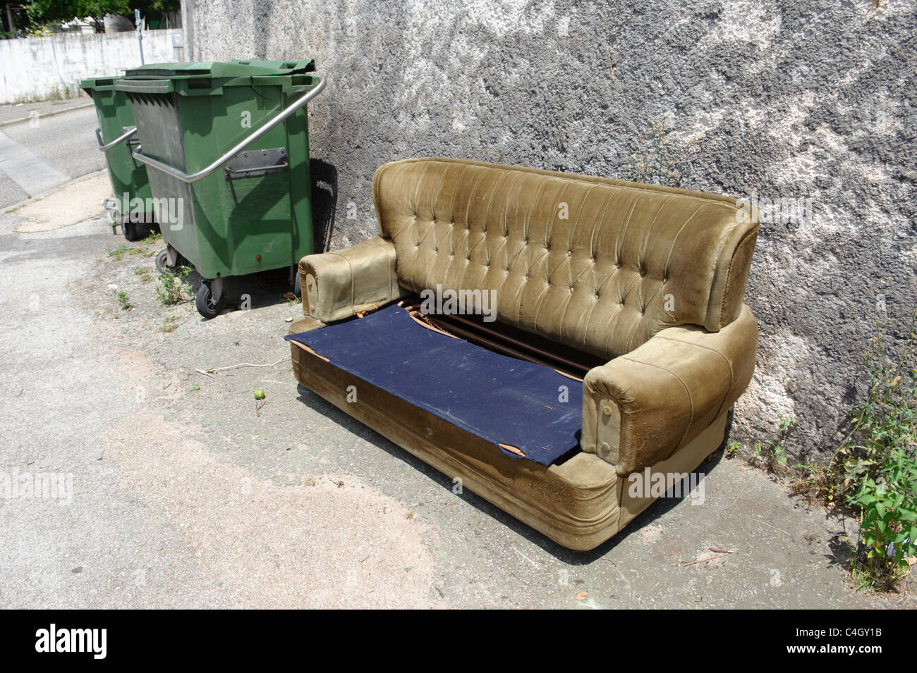 Abandoned sofa in a street Stock Photo - Alamy