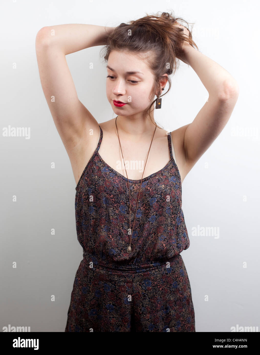 Portrait of young woman holding her hair up Stock Photo - Alamy