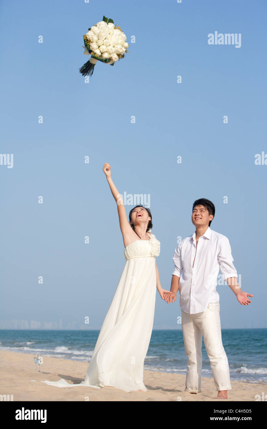 Bride Tossing Bouquet in the Air Stock Photo - Alamy