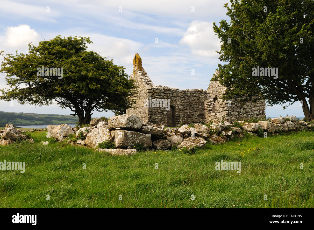 Remains of 12th century Lligwy Chapel overlooking Lligwy Bay Moelfre ...