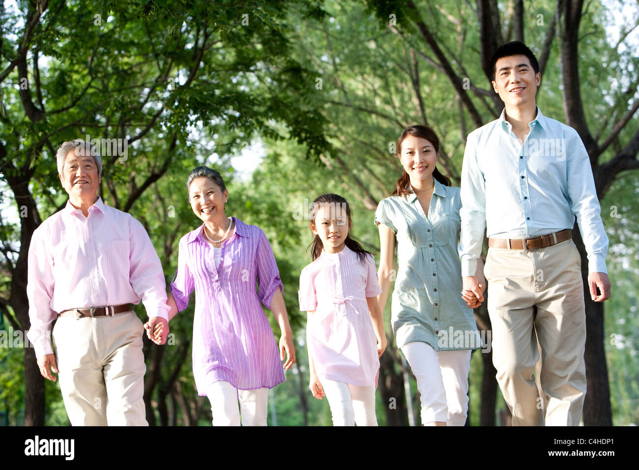 Family Walking Through the Park Stock Photo - Alamy