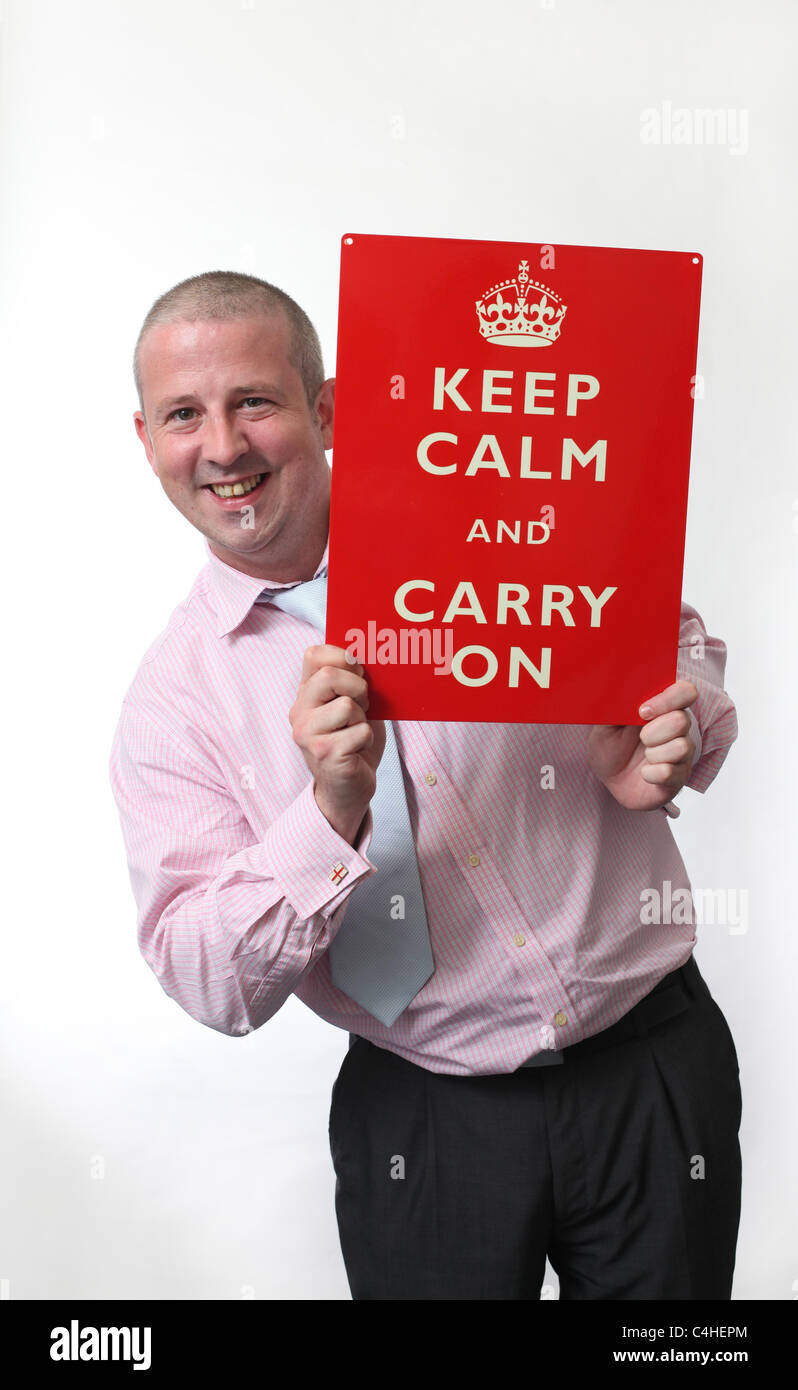 Man holding a Keep Calm And Carry On sign. Picture by James Boardman ...