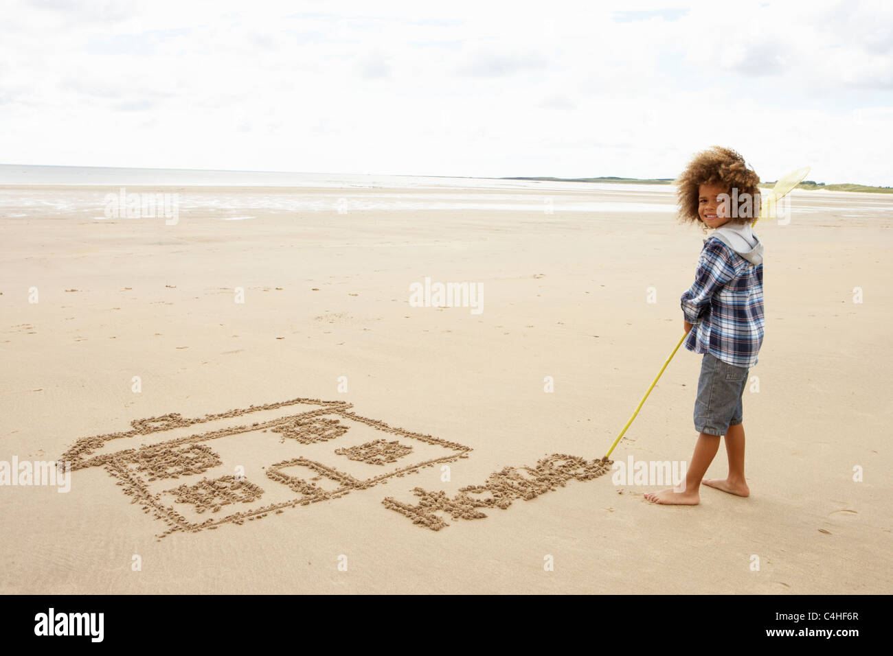 Boy drawing in sand stick hi-res stock photography and images - Alamy