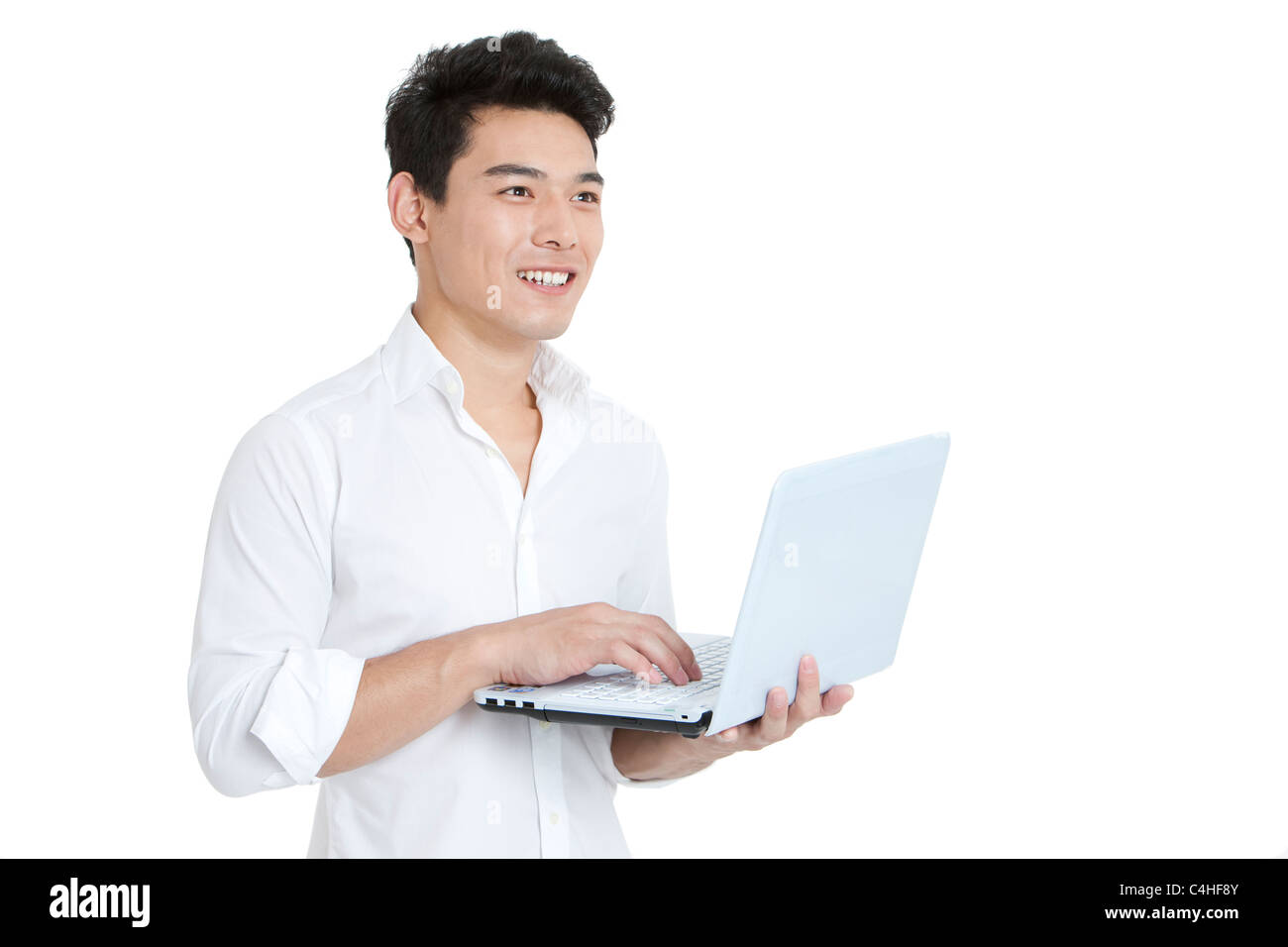 Portrait of a young man using laptop Stock Photo - Alamy