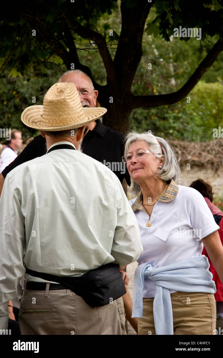 Three mature people talking Stock Photo - Alamy