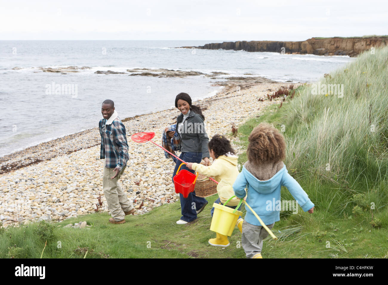 Young family beach collecting shells hi-res stock photography and ...