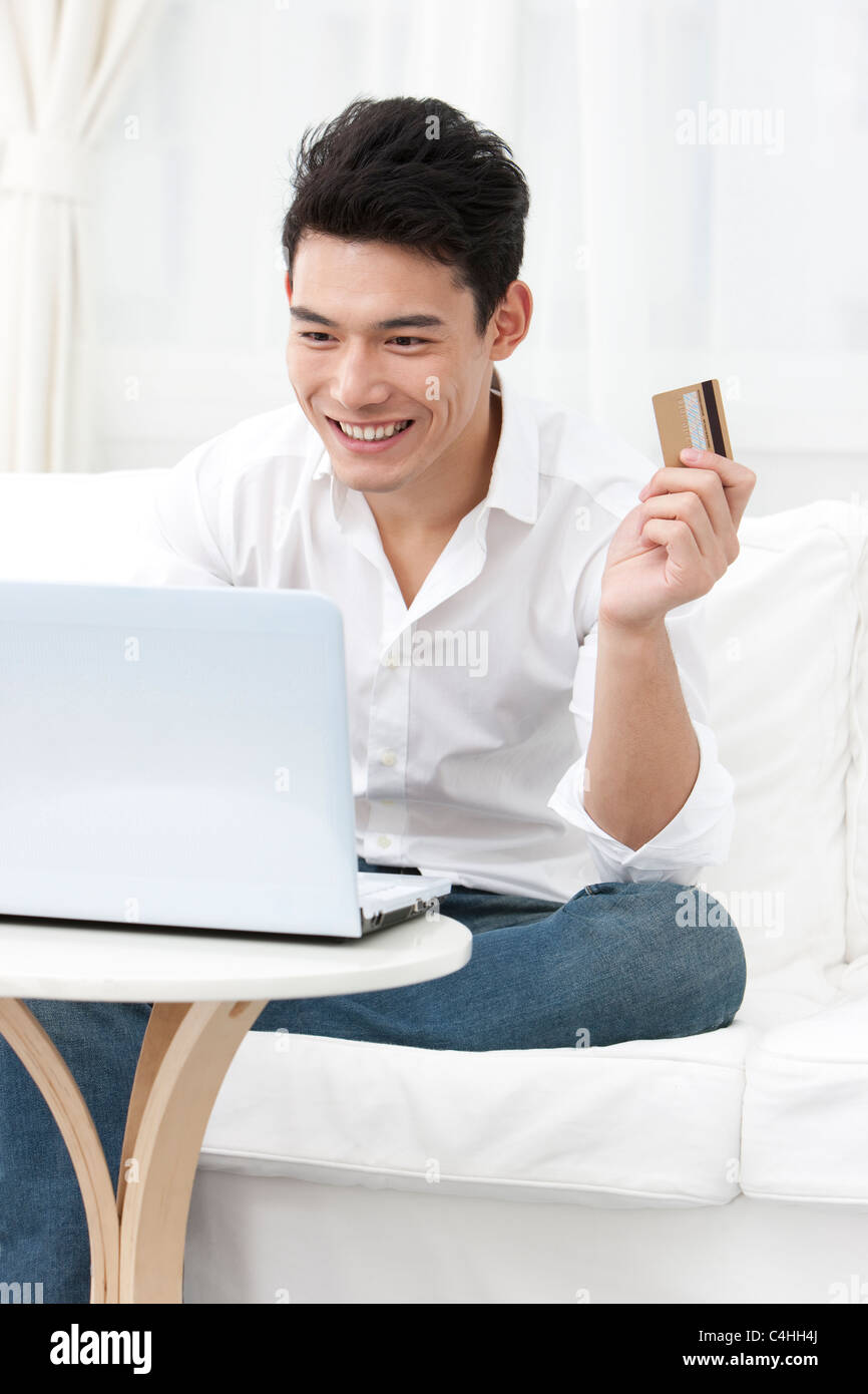 Young man online shopping Stock Photo - Alamy