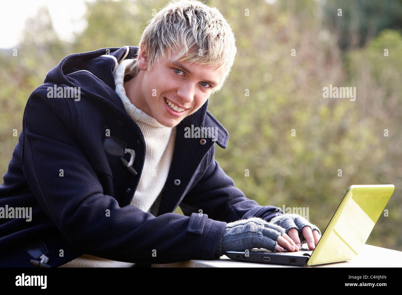 Young man with laptop computer Stock Photo - Alamy
