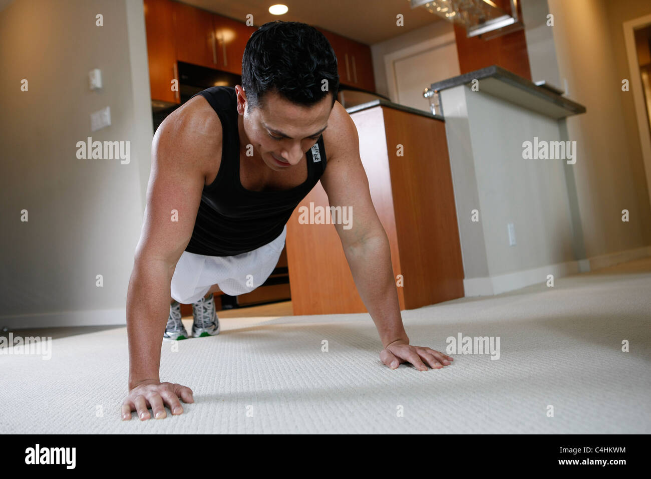 Fit guy working out at home Stock Photo - Alamy