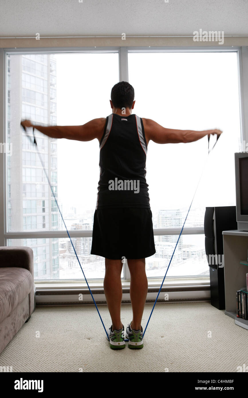 Fit guy working out at home Stock Photo - Alamy