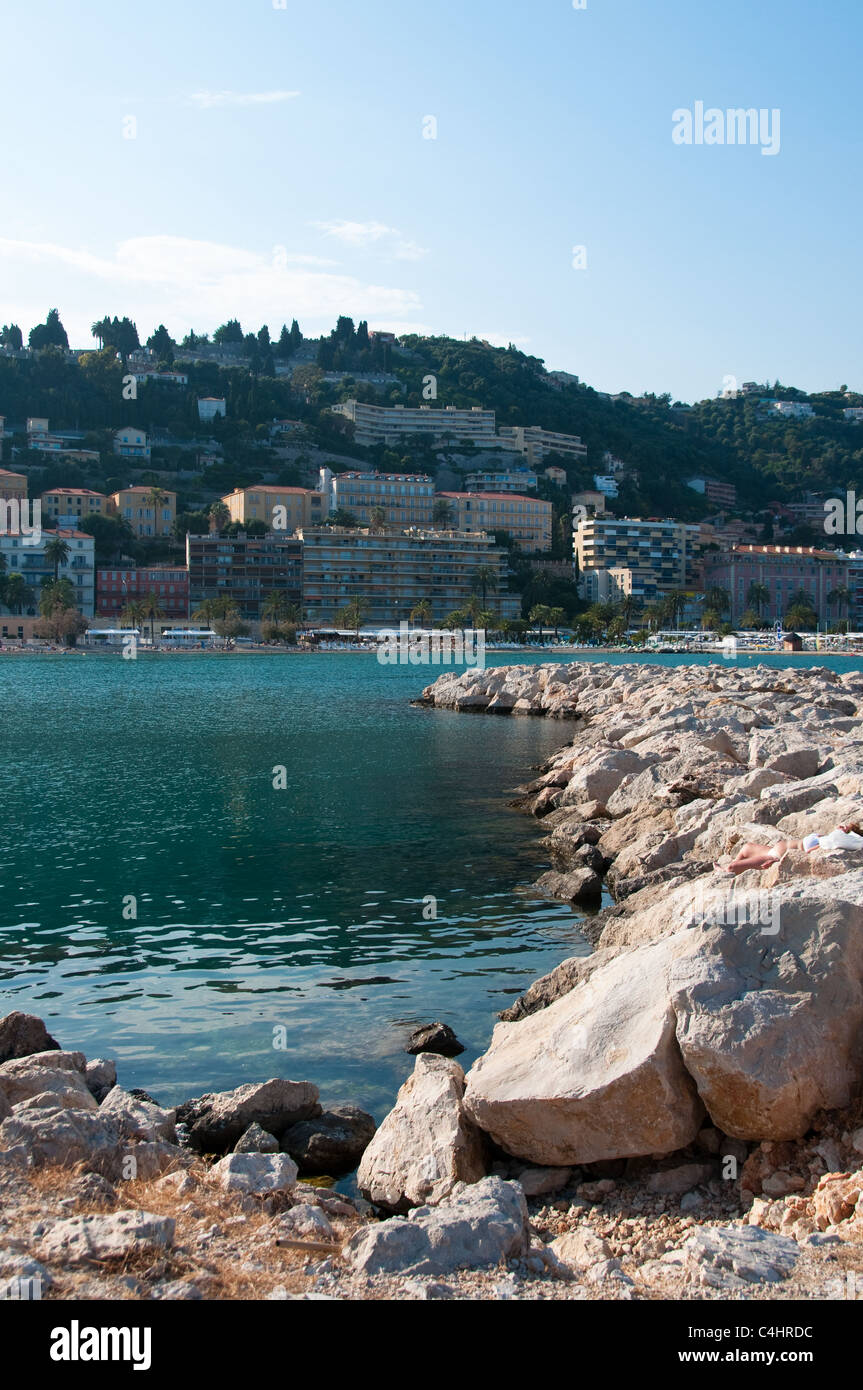 Turquoise seashore of an european city with a rock path Stock Photo - Alamy
