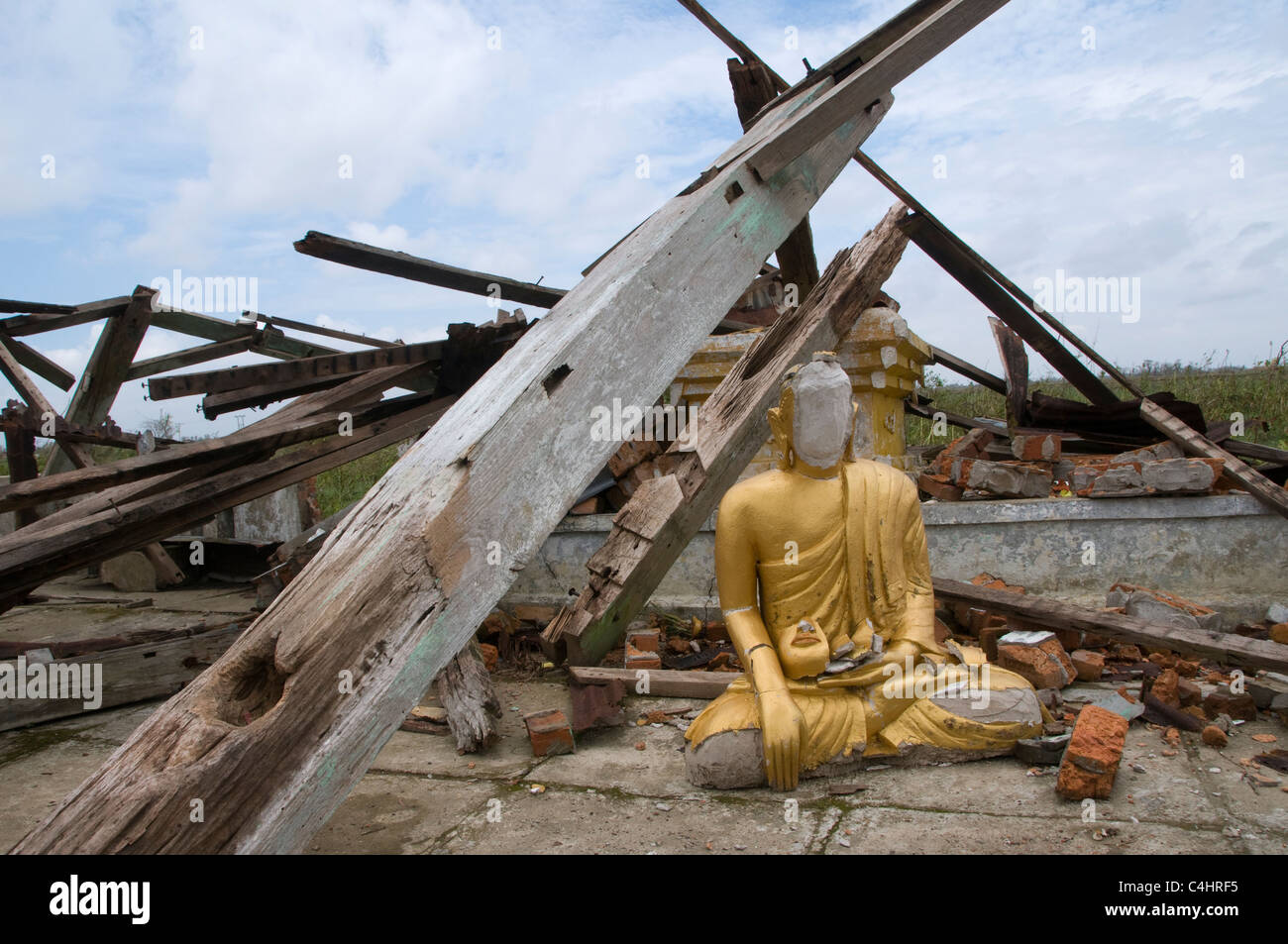 A large Buddha statue stands in a ruined temple caused by Cyclone ...