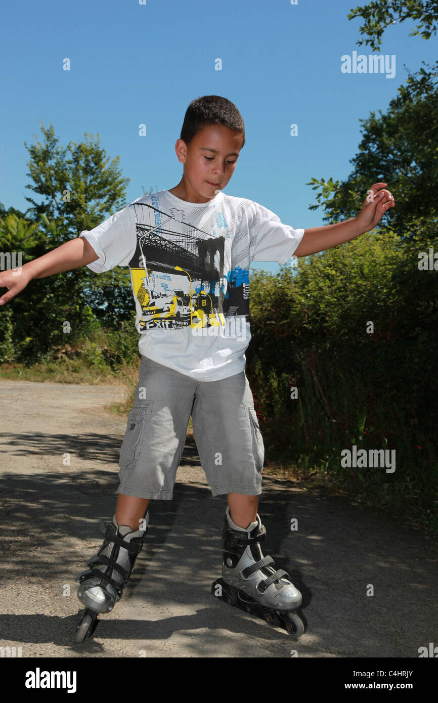 Boy learning to rollerblade Stock Photo - Alamy