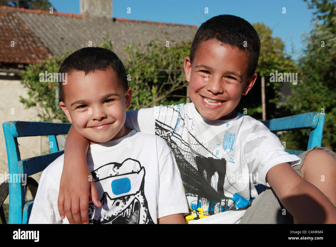 2 mixed race brothers smiling at the camera Stock Photo - Alamy