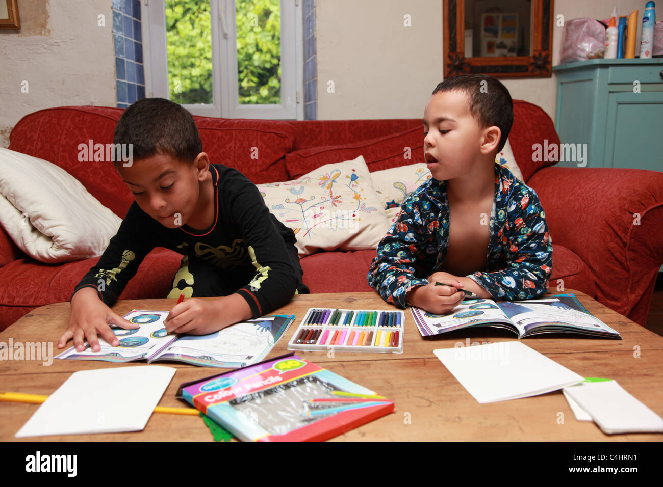 Kids writing and colouring in Stock Photo - Alamy