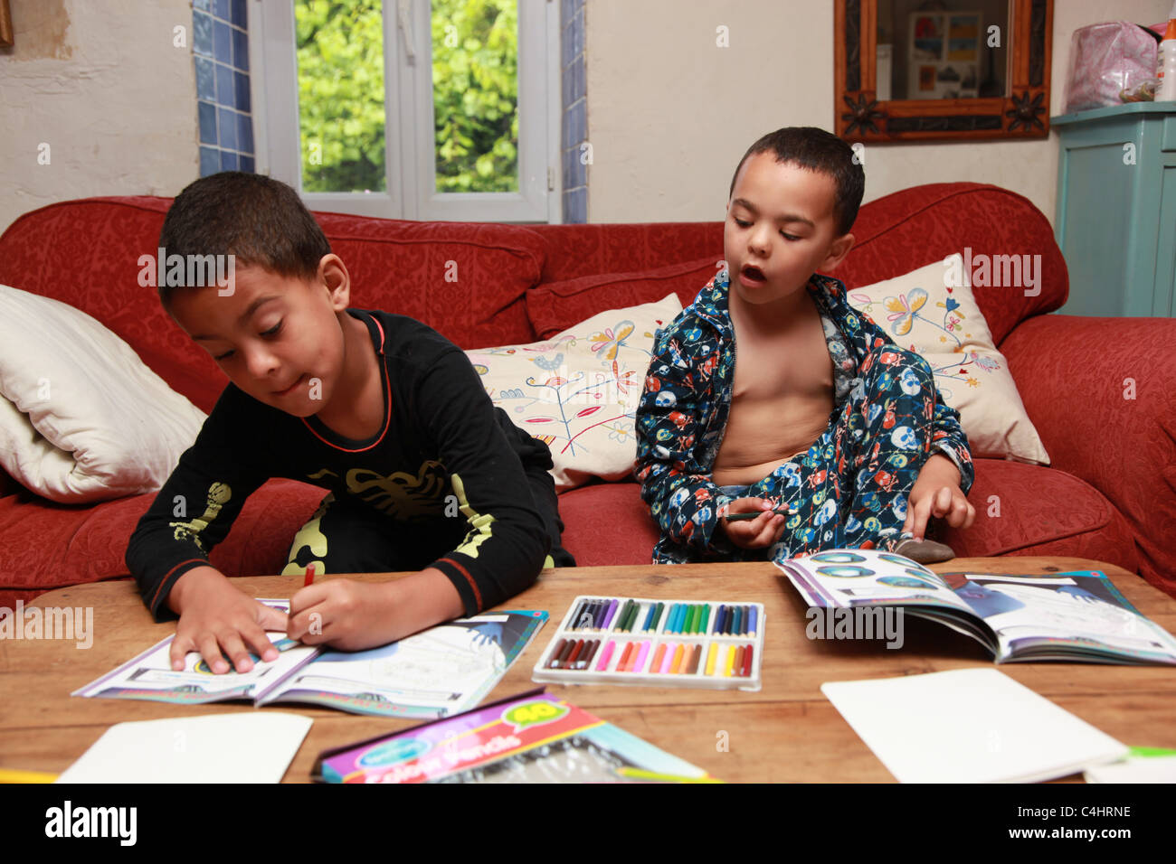 Kids writing and colouring in Stock Photo - Alamy