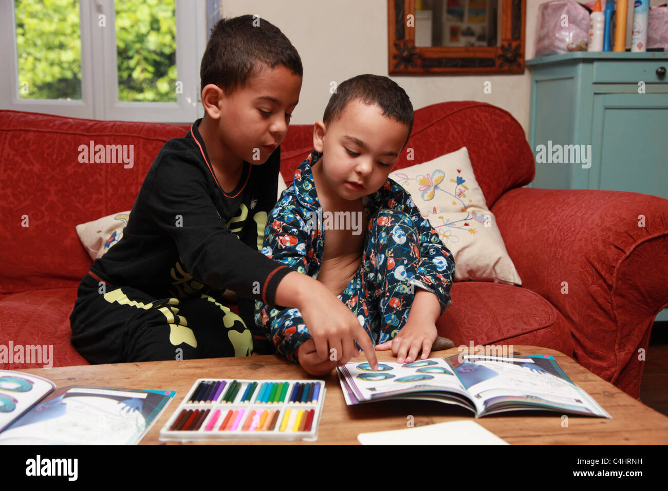 Kids writing and colouring in Stock Photo - Alamy