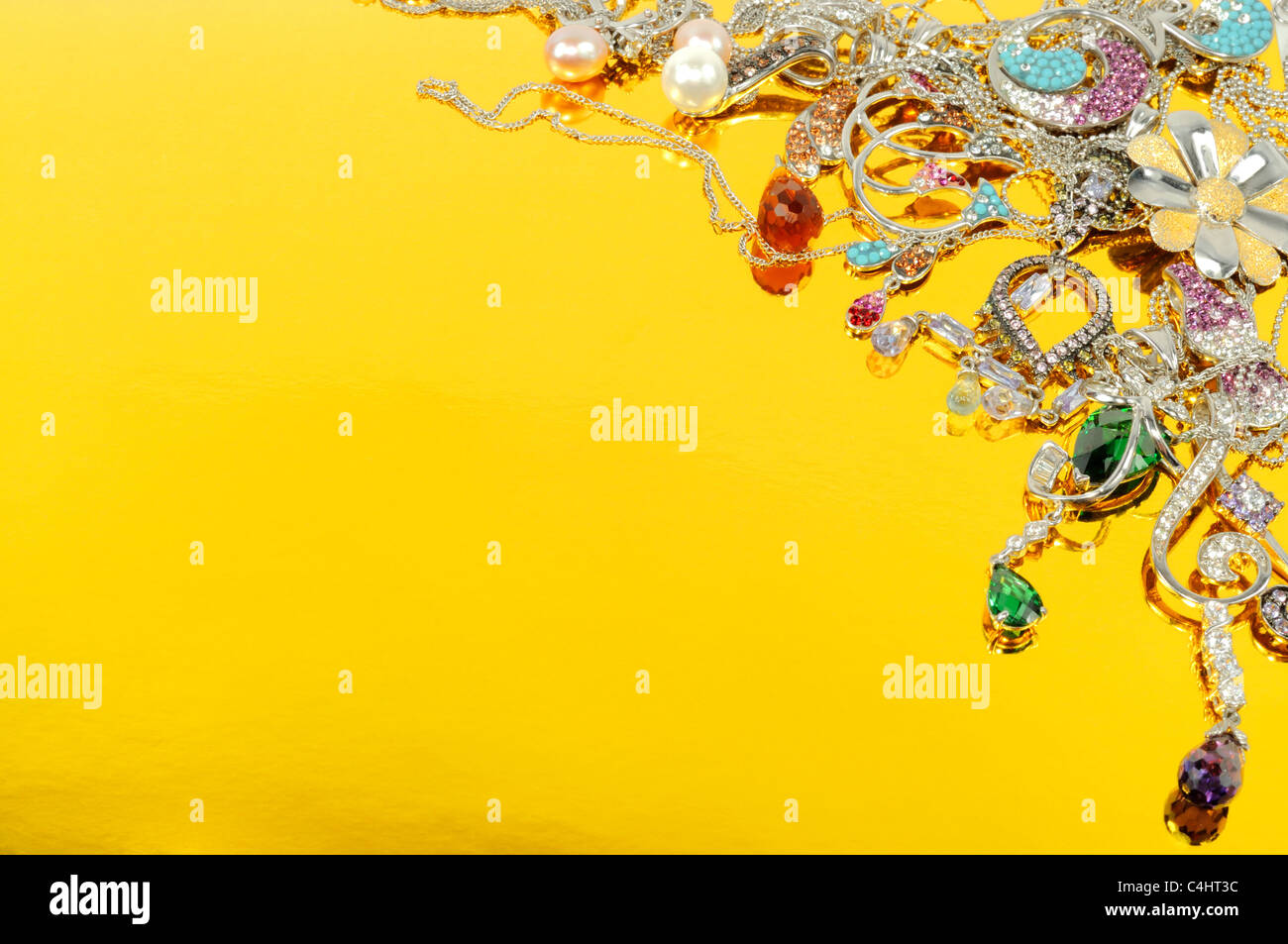 Jewelry from white gold, isolated on gold background Stock Photo - Alamy