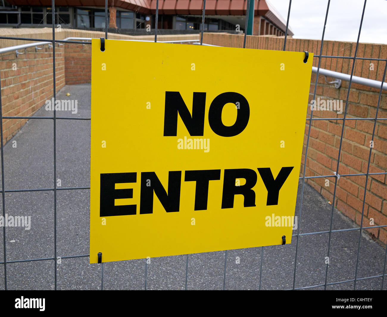 No entry sign with a metal mesh barrier blocking a ramp access along ...