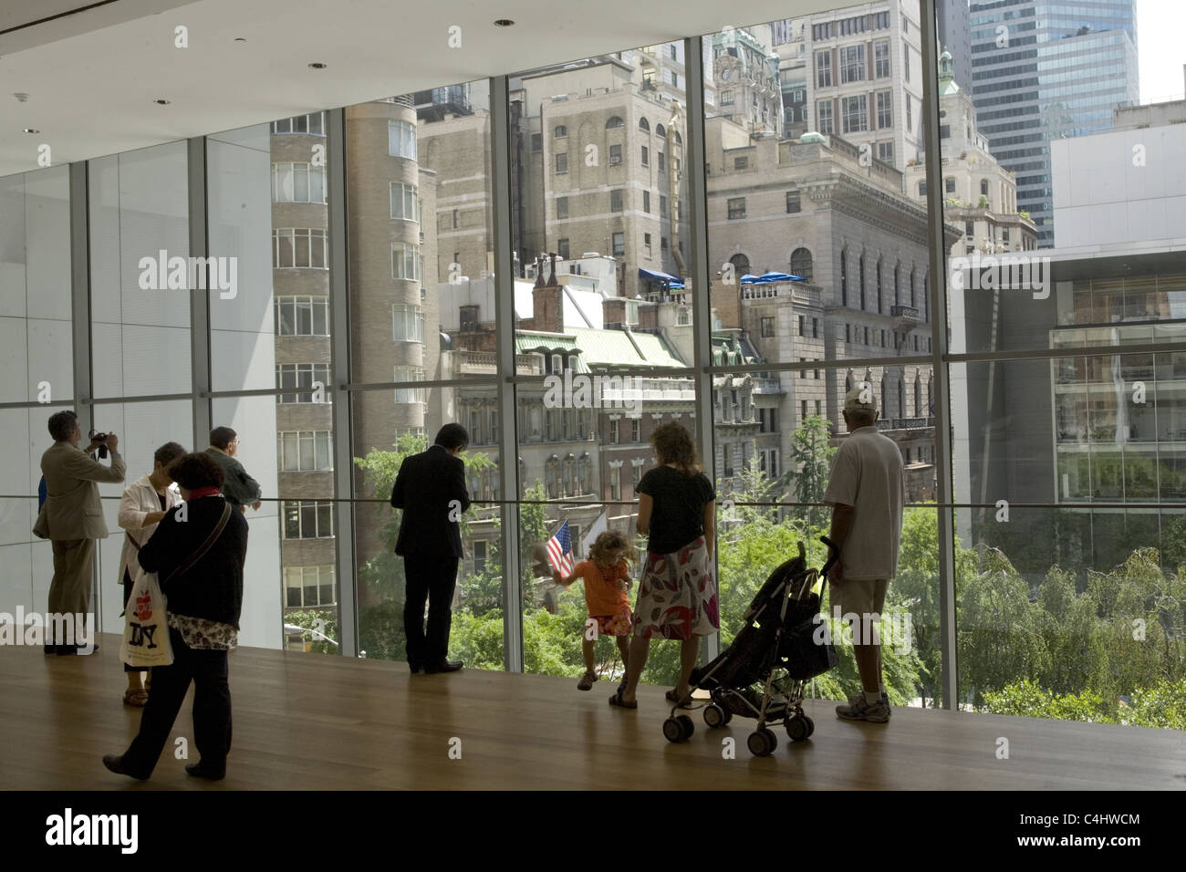 Large windows in the Museum Of Modern Art look out into midtown ...