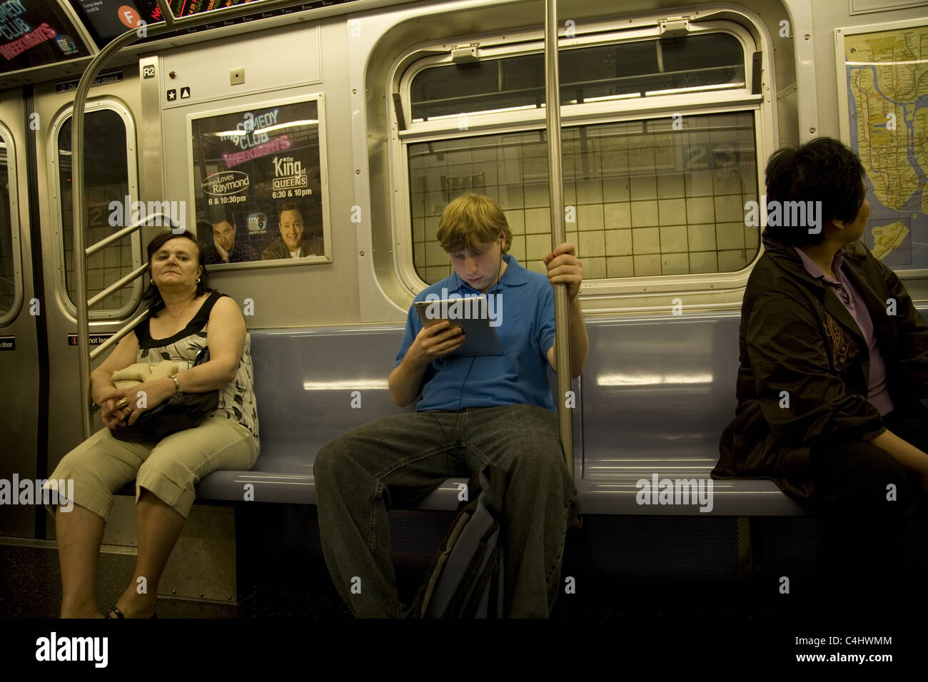 Young man immersed in his ipad screen while plugged into his ipod while ...