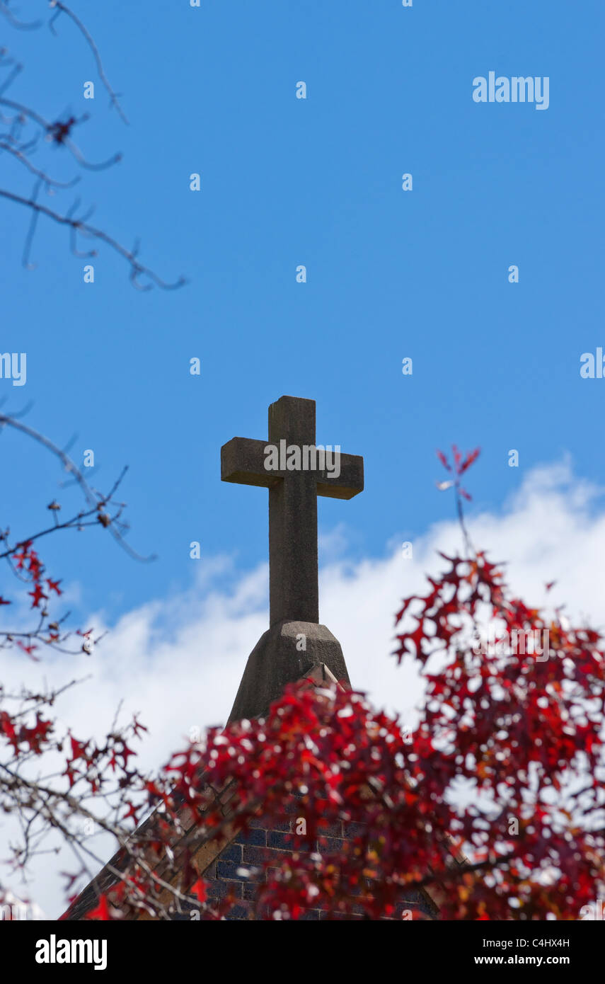 cross on church or chapel through red autumn fall leaves Stock Photo ...