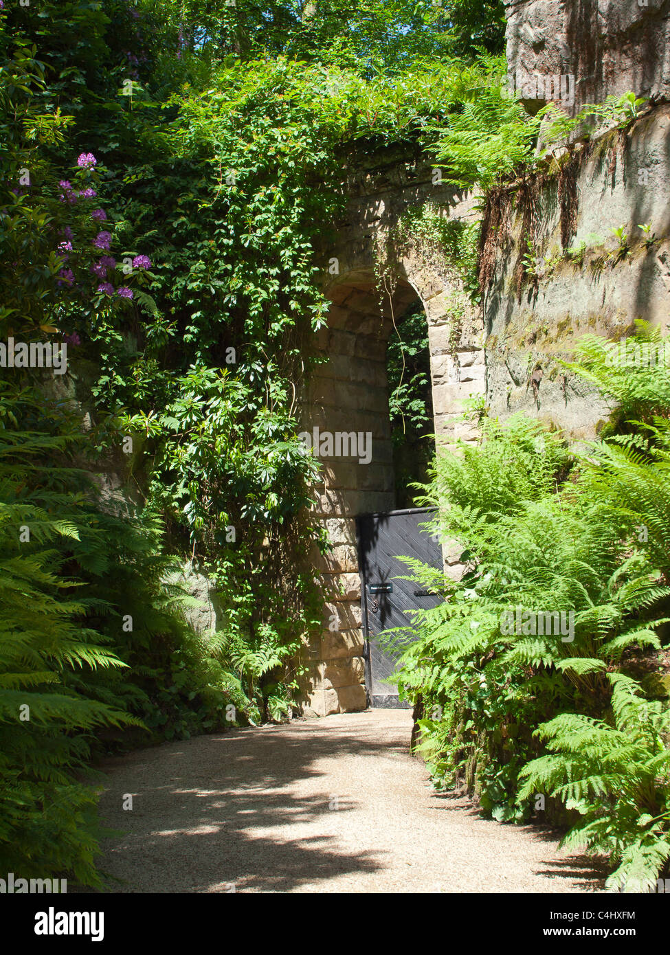 High stone archway in the Quarry Garden at Belsay Hall Northumberland ...