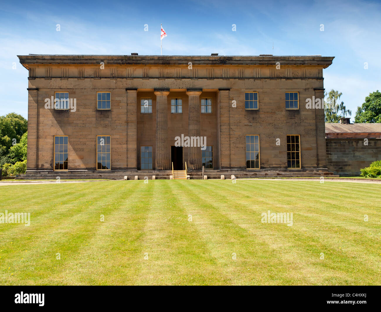 Belsay Hall front elevation across a neatly trimmed lawn Stock Photo ...