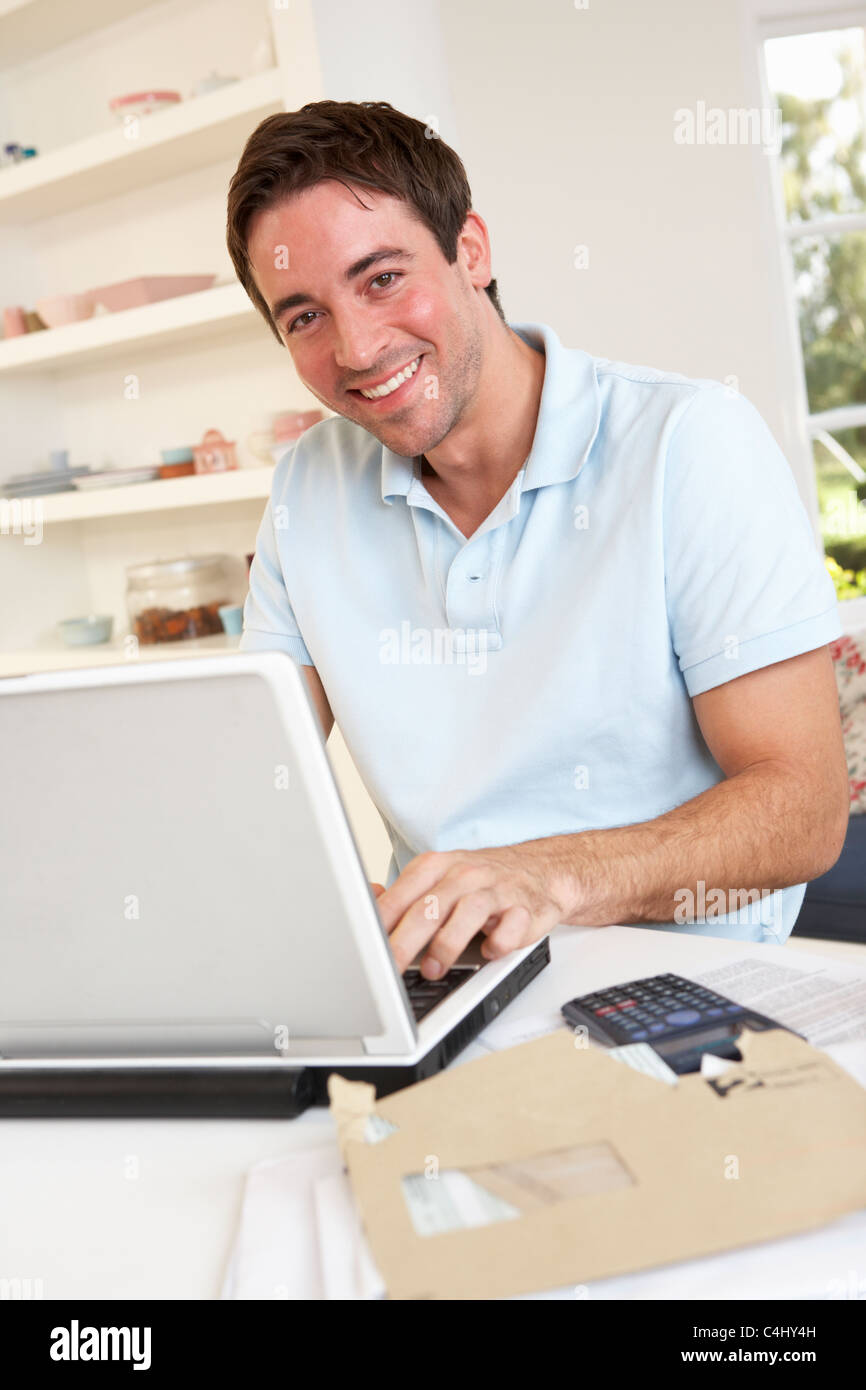 Young man working with laptop computer Stock Photo - Alamy