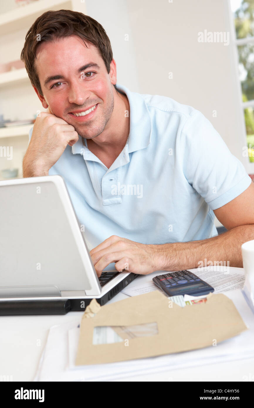 Young man working with laptop computer Stock Photo - Alamy