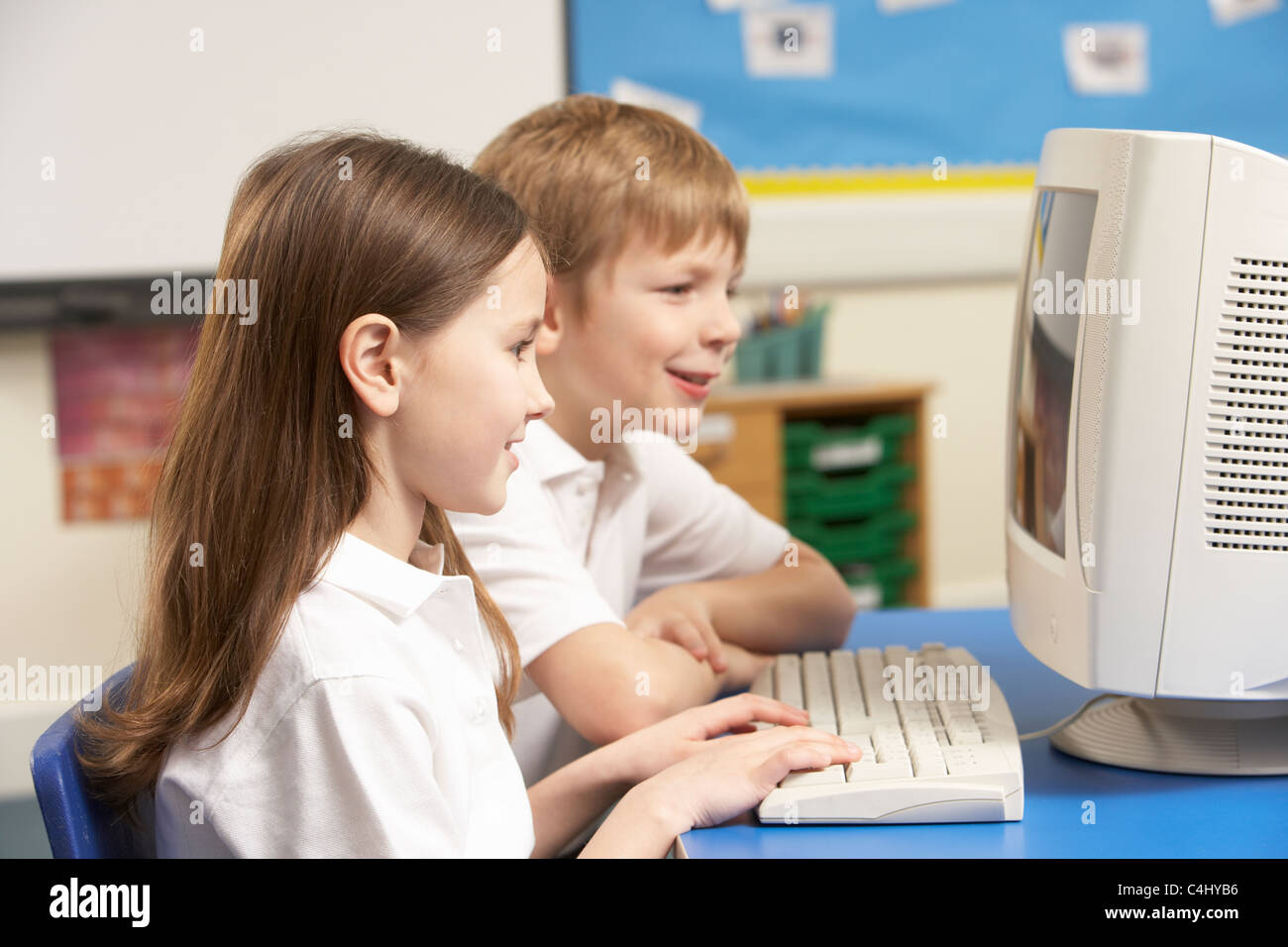 Schoolchildren In IT Class Using Computer Stock Photo - Alamy