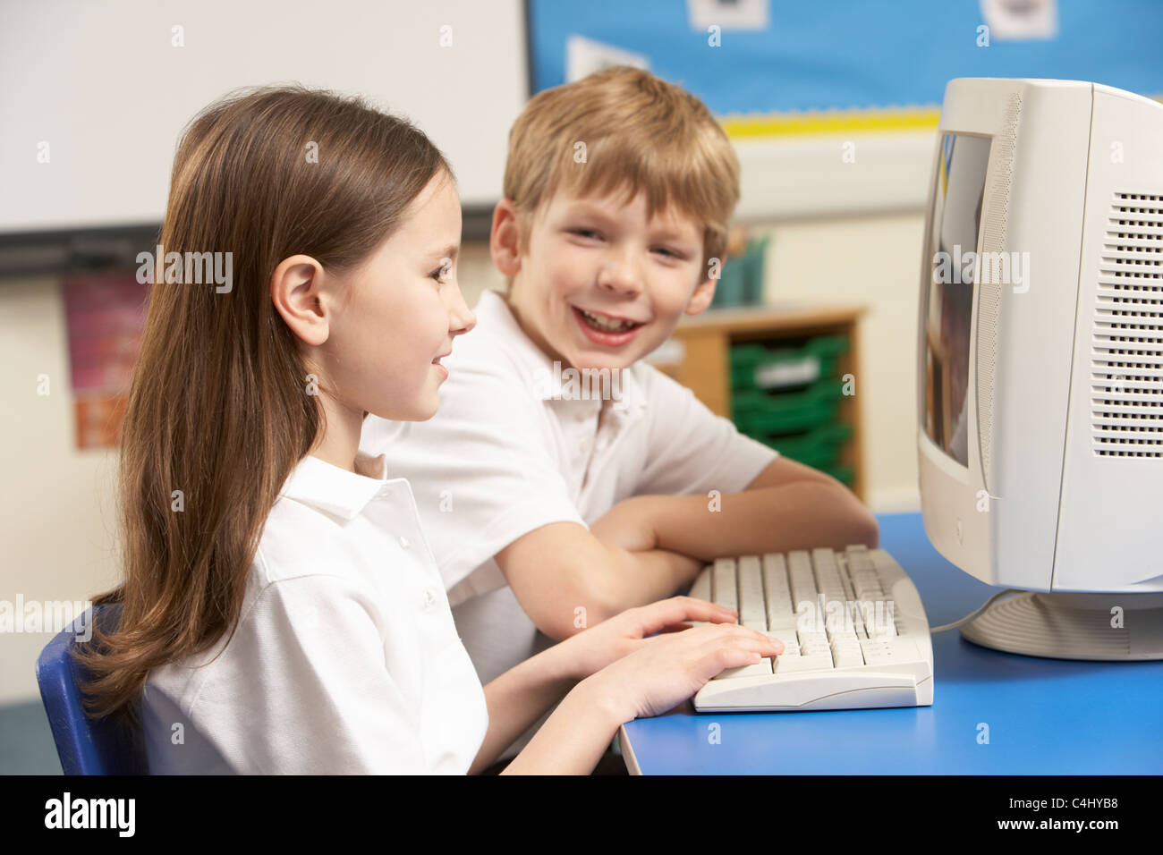 Schoolchildren In IT Class Using Computer Stock Photo - Alamy