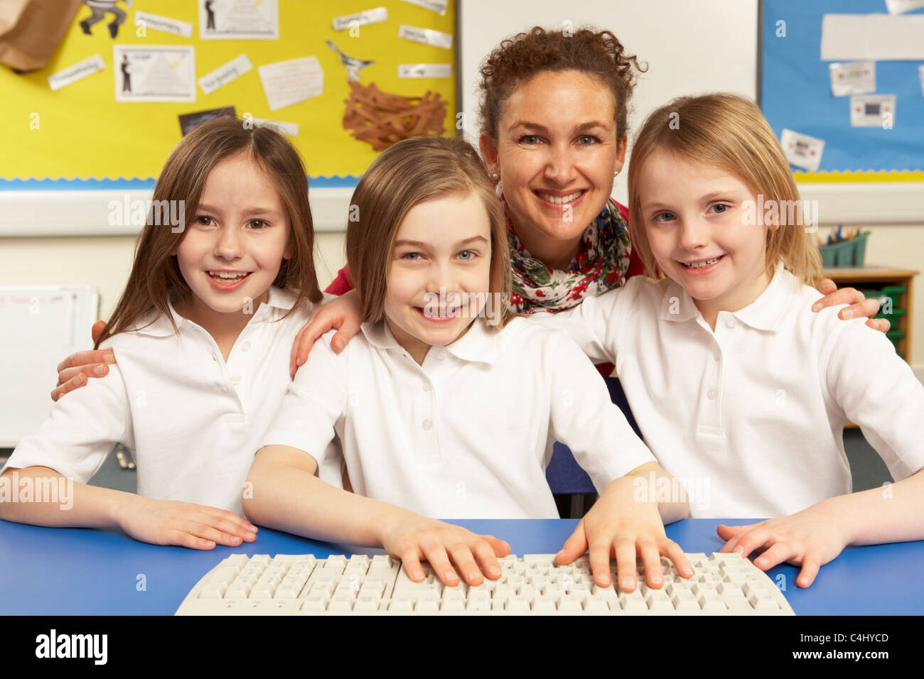 Schoolchildren in IT Class Using Computers With Female Teacher Stock ...