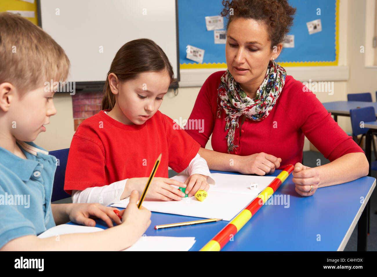 Schoolchildren Studying in classroom with teacher Stock Photo - Alamy
