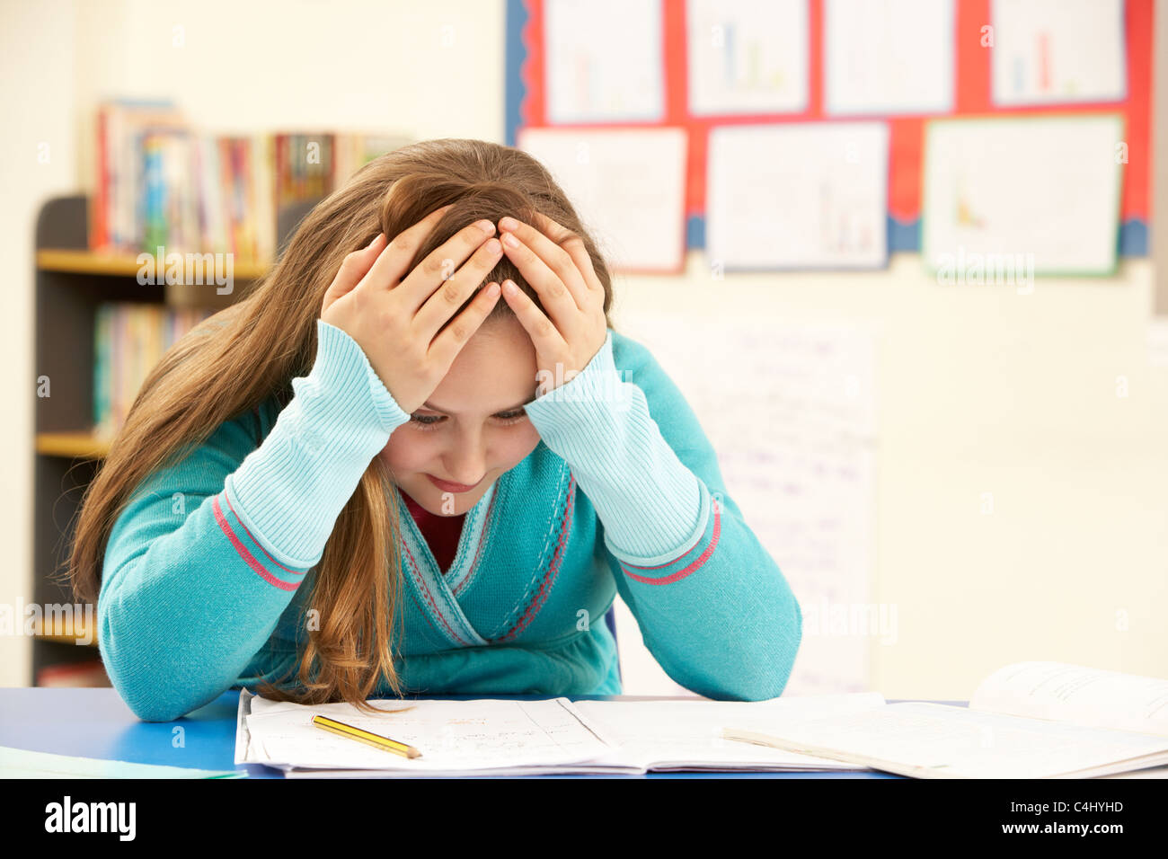 Stressed Schoolgirl Studying In Classroom Stock Photo - Alamy
