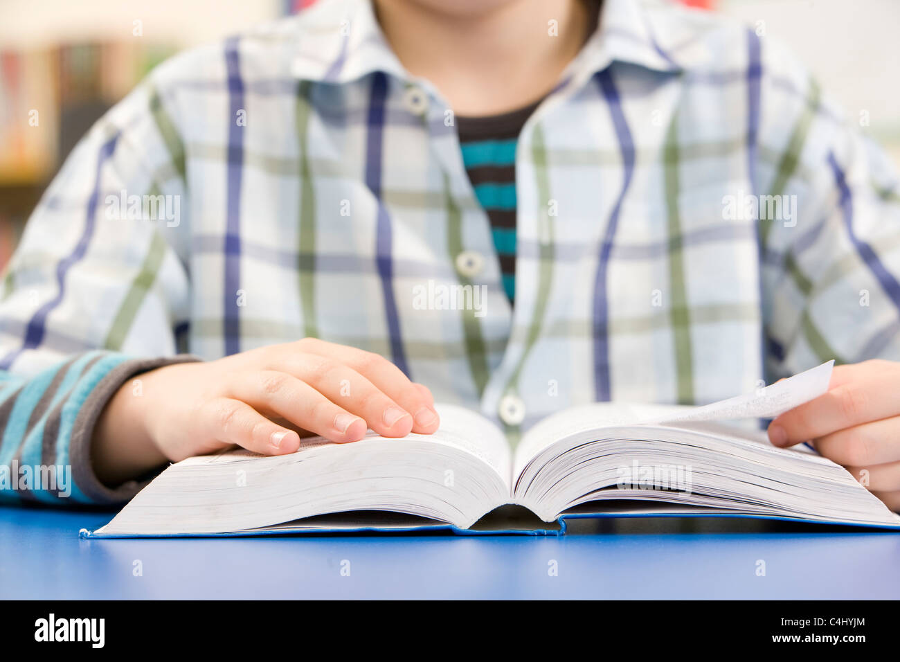Close Up Of Schoolboy Studying Textbook In Classroom Stock Photo - Alamy