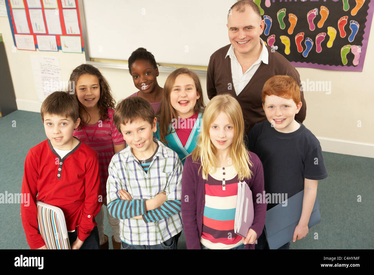 Portrait Of Schoolchildren Standing In Classroom Stock Photo - Alamy