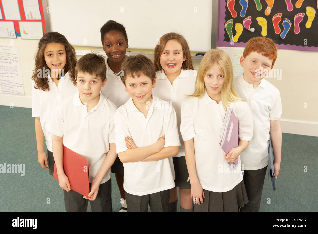 Portrait Of Schoolchildren Standing In Classroom Stock Photo - Alamy