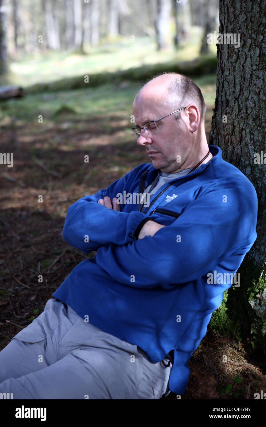 Man asleep under a tree Stock Photo - Alamy