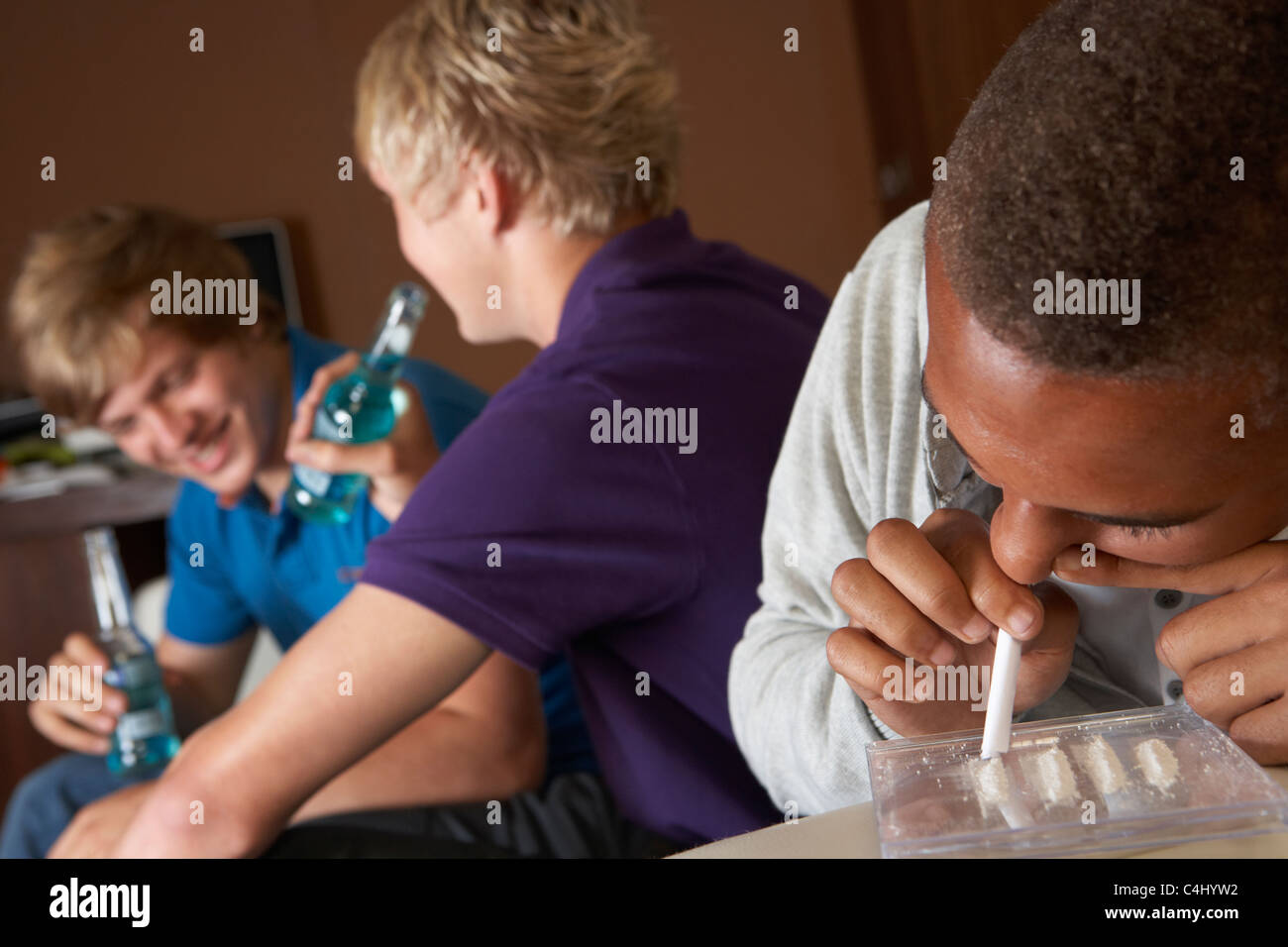 Group Of Teenage Boys Taking Drugs At Home Stock Photo - Alamy