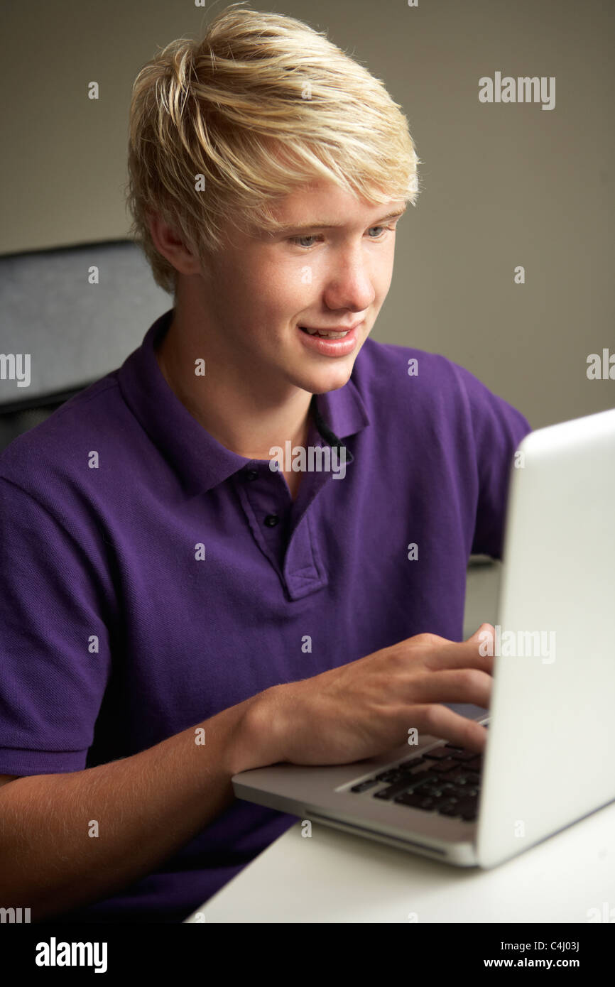 Teenage Boy Using Laptop At Home Stock Photo - Alamy