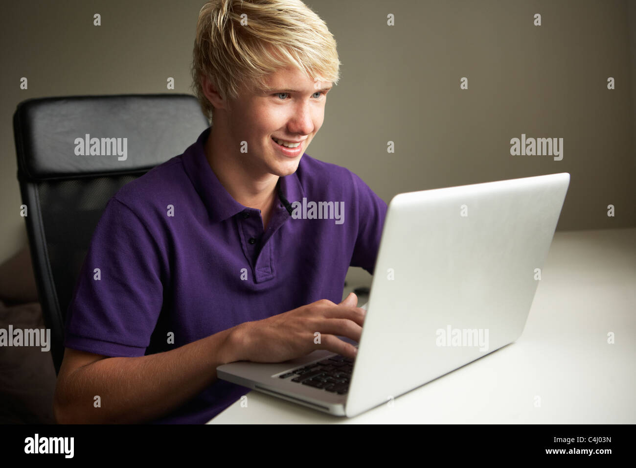 Teenage Boy Using Laptop At Home Stock Photo - Alamy