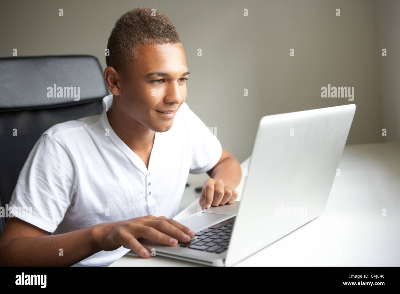 Teenage Boy Using Laptop At Home Stock Photo - Alamy