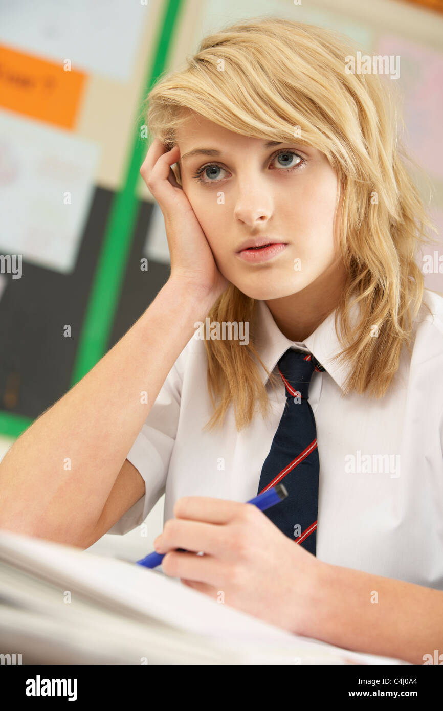 Stressed Female Teenage Student Studying In Classroom Stock Photo - Alamy