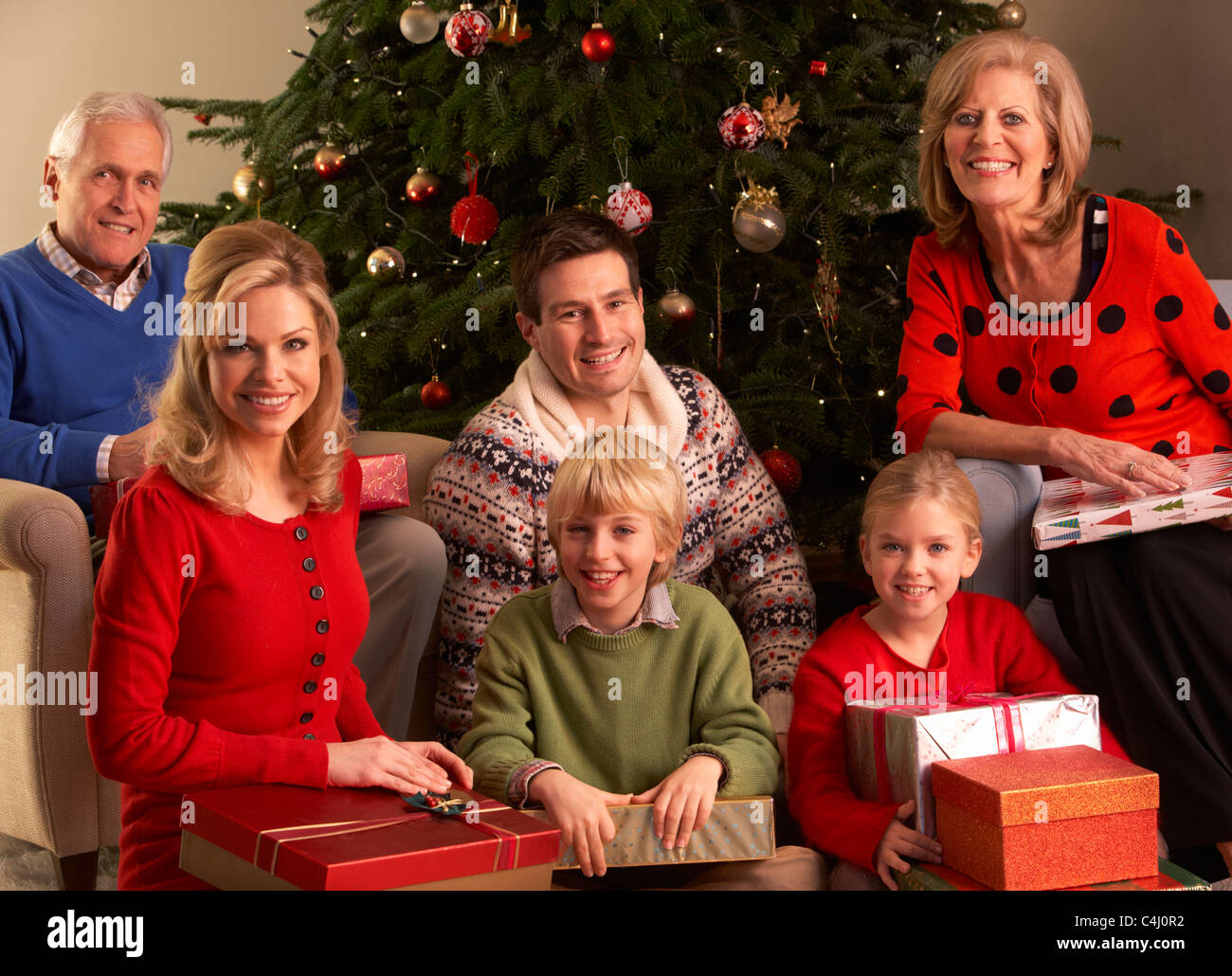 Three Generation Family Opening Christmas Gifts At Home Stock Photo - Alamy