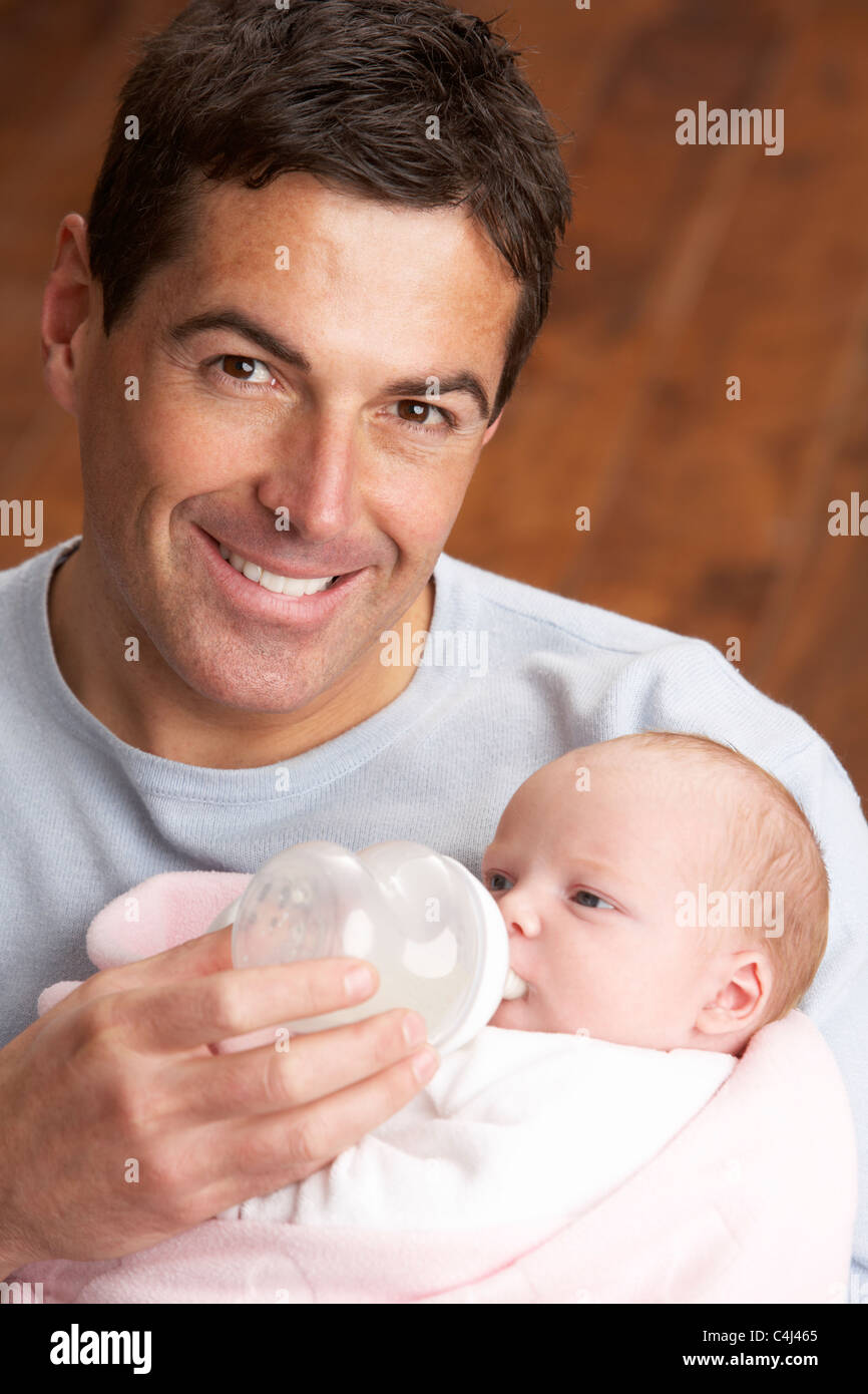 Young man feed newborn baby hi-res stock photography and images - Alamy