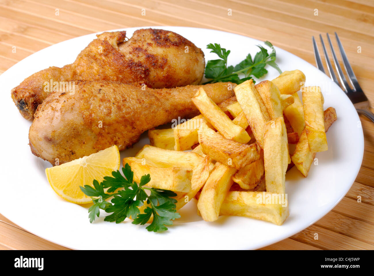 Fried chicken legs and potato chips Stock Photo - Alamy
