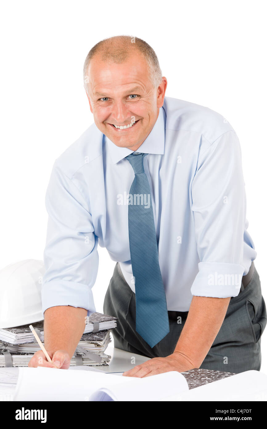 Professional senior architect with protective helmet and blueprints ...